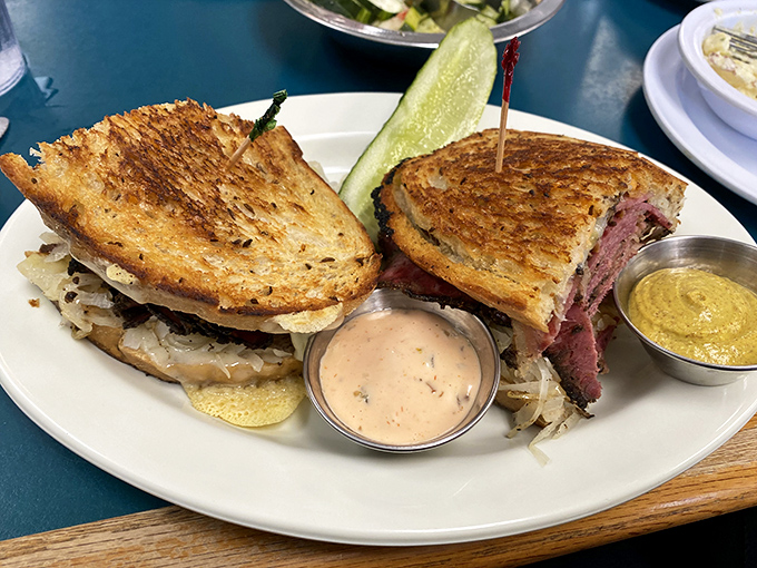 The Reuben arrives like a skyscraper of flavor—perfectly grilled rye supporting the delicate balance of corned beef, sauerkraut, and Russian dressing architecture.