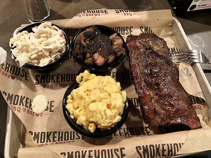 Behold the holy trinity of barbecue – perfectly smoked ribs with that telltale pink ring, creamy mac and cheese, and coleslaw for that essential tang.