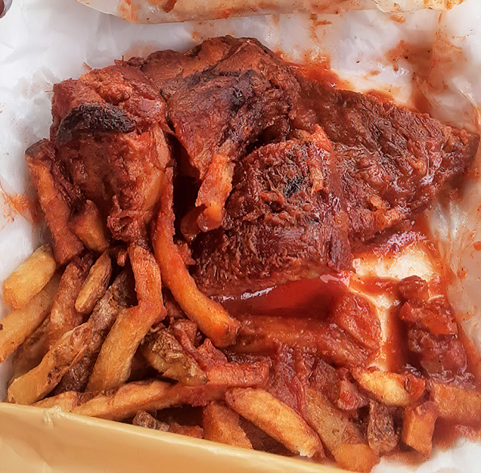 These rib tips aren't just falling off the bone—they're practically jumping onto your fork. The sauce-soaked fries underneath are the unsung heroes of this plate.