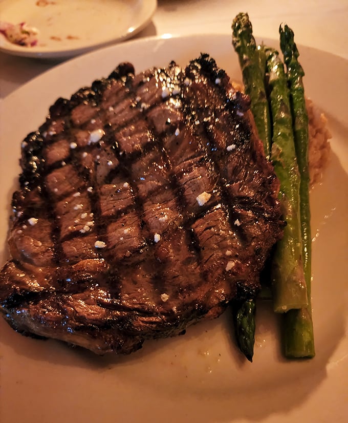 Behold the ribeye that's earned legendary status - perfectly charred outside, tender pink perfection within.