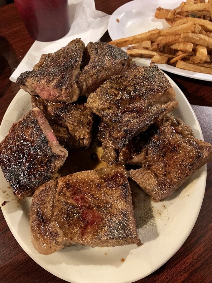 Behold the star of the show—a perfectly seasoned ribeye with that magical char that whispers, "Yes, this was worth the drive."
