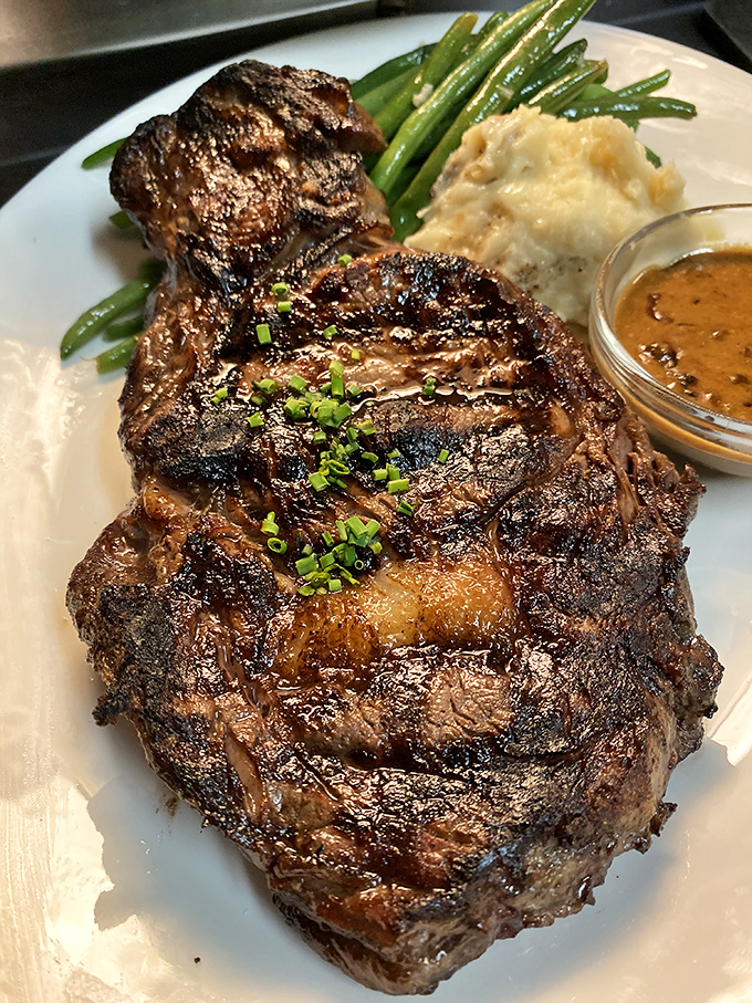 This isn't just a steak; it's a masterpiece of marbling and char that would make even the most dedicated vegetarian consider a temporary career change.