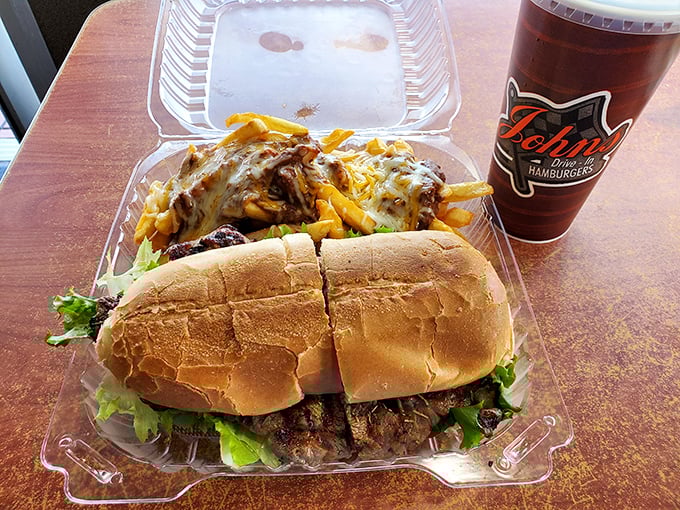 This isn't just lunch, it's an architectural marvel—a ribeye sandwich foundation supporting a glorious skyscraper of chili cheese fries.