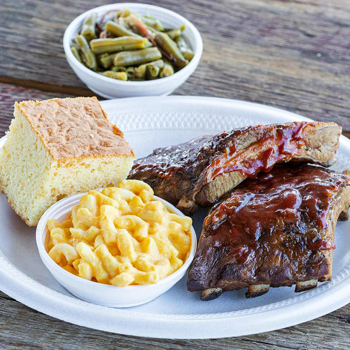 Glistening ribs with that perfect bark, mac and cheese that's unapologetically yellow, and cornbread that would make your grandma jealous. The holy trinity of Southern comfort.