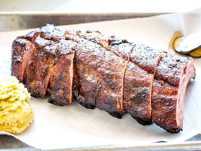 Behold the holy grail of barbecue—ribs with that perfect mahogany bark and pink smoke ring. Poetry doesn't need words when it looks like this.