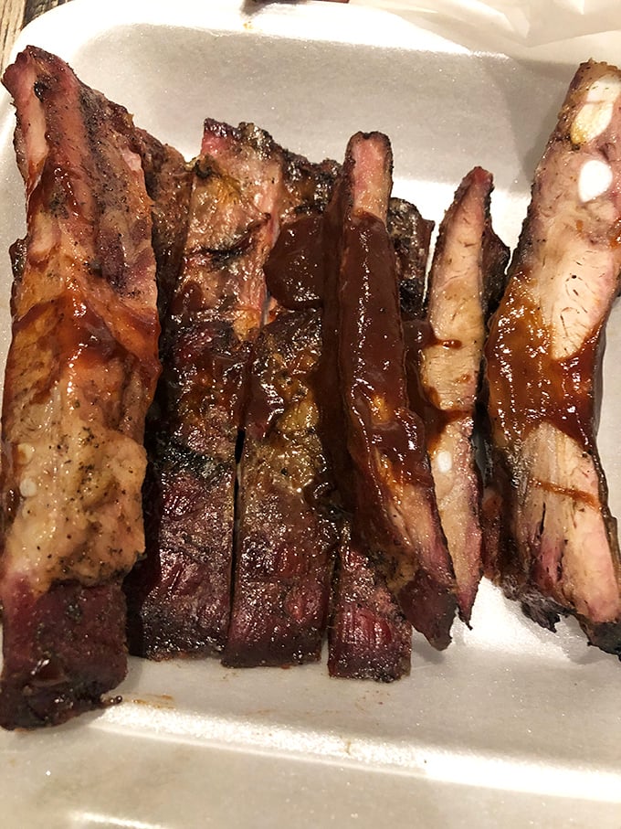 These ribs aren't falling off the bone – they're clinging to it with just the right amount of resistance. BBQ perfection.