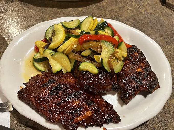 These baby back ribs don't just fall off the bone—they practically leap onto your fork, bringing smoky-sweet satisfaction with every bite.