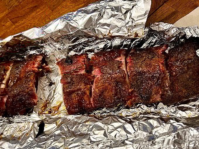 These ribs don't just have a smoke ring—they have a smoke halo. The kind of bark that makes you want to compose sonnets about pork.