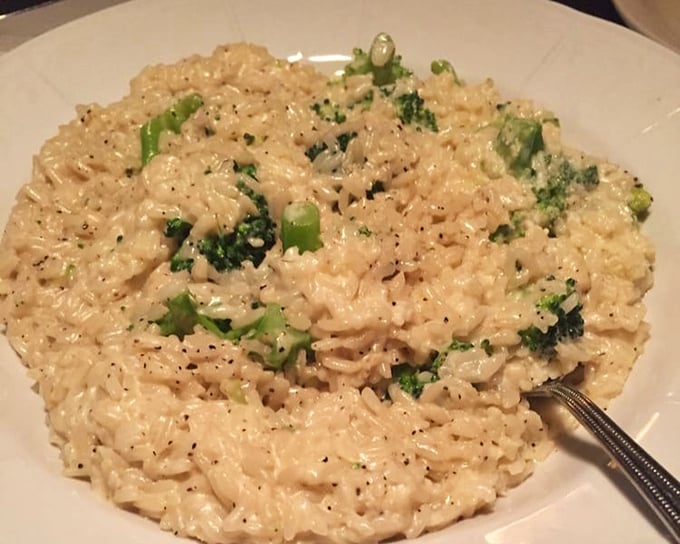 Creamy risotto studded with vibrant broccoli – proof that patience isn't just a virtue, it's the secret ingredient in this velvety masterpiece.
