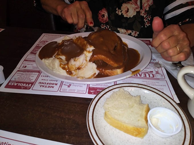Behold the legendary roast beef – tender enough to cut with a whisper, swimming in gravy that should be declared a national treasure.