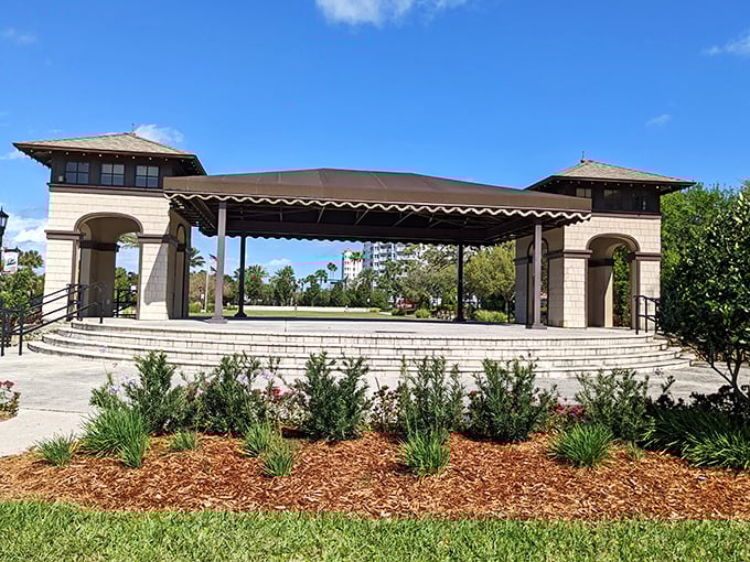 This elegant bandshell waits patiently for its next performance, surrounded by landscaping so perfect it makes your home garden feel personally attacked.