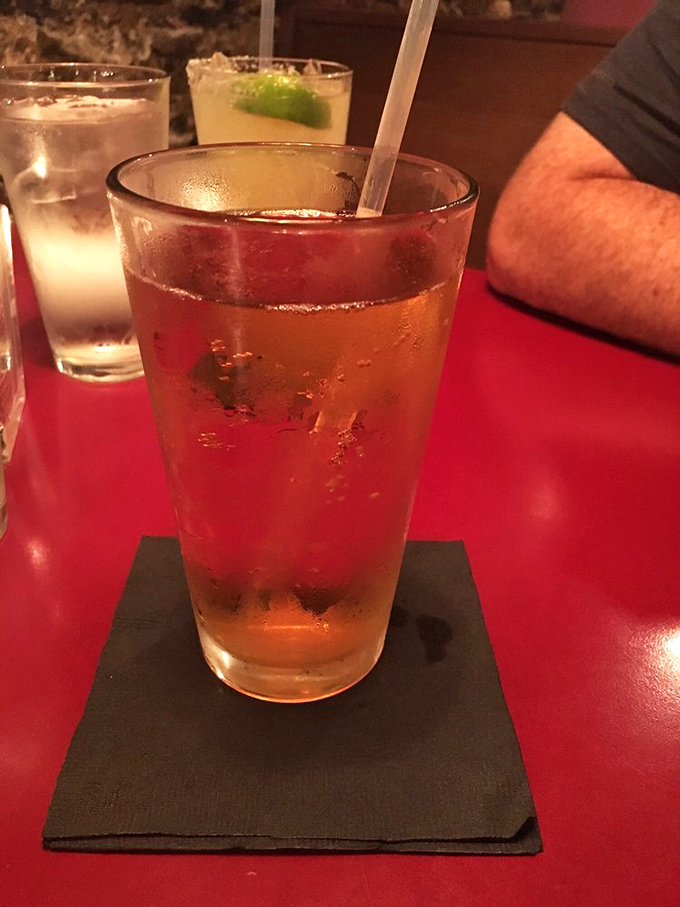 That's not just any beverage—it's liquid amber perfection in a glass, condensation beading on the side like nature's own promise of refreshment.