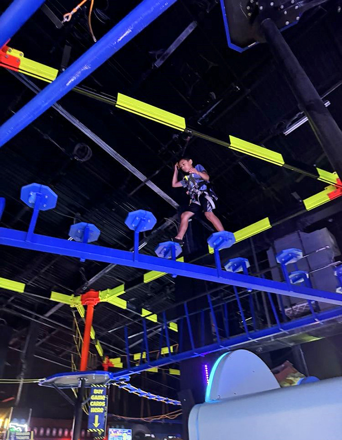 Gravity is merely a suggestion at the WonderWorks ropes course, where visitors navigate neon-lit obstacles suspended high above the ground.