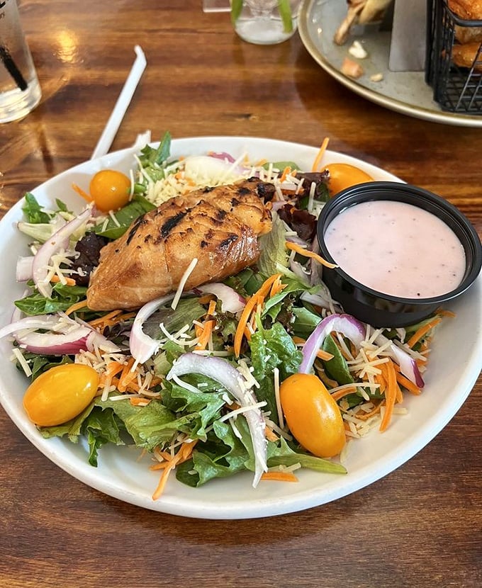 Not all heroes wear capes—some come on a bed of fresh greens with colorful veggies, shredded cheese, and a side of house-made dressing.