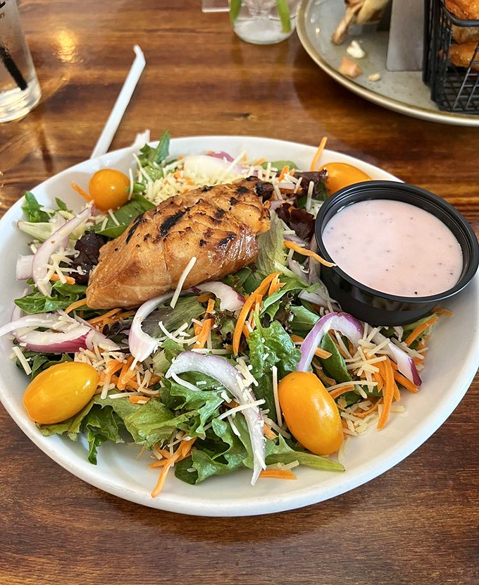 Not all heroes wear capes—some come on a bed of fresh greens with colorful veggies, shredded cheese, and a side of house-made dressing.