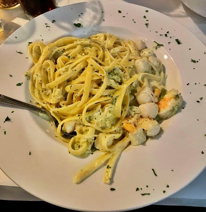 The legendary seafood Alfredo in all its glory—where tender shrimp and scallops swim in creamy paradise. Worth every mile of the drive.