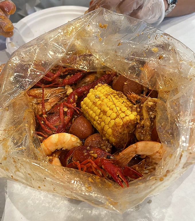 Behold the plastic bag of dreams! Crawfish, shrimp, corn, and potatoes swimming in flavor-packed sauce – nature's perfect one-bag meal.