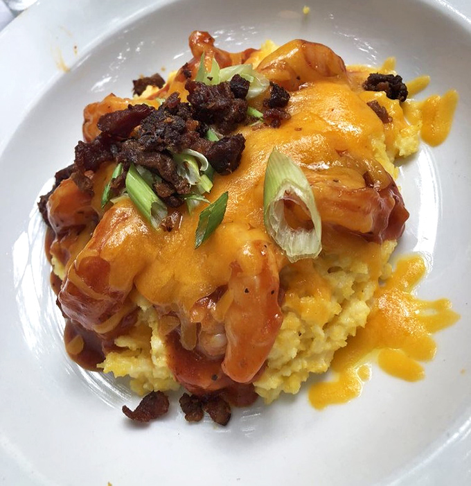 Behold the legendary barbecue shrimp and grits—a masterpiece of creamy yellow cornmeal topped with plump shrimp, crispy bacon, and scallions. Southern comfort redefined.