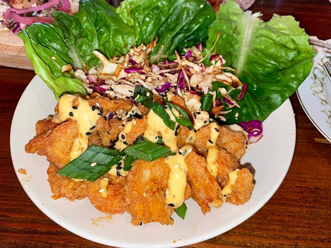 These aren't your average lettuce wraps – crispy shrimp nestled in butter lettuce with Asian slaw creates a perfect harmony of crunch, spice, and freshness.