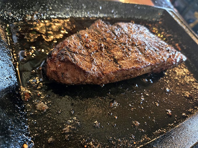 That sirloin isn't just cooked—it's transformed. The perfect crust seals in juices that would make even vegetarians reconsider their life choices.