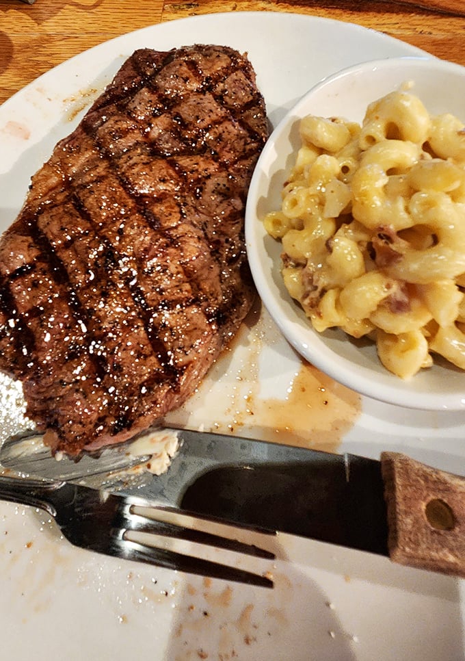 A perfectly grilled sirloin alongside creamy mac and cheese—proof that sometimes the simplest combinations create the most profound happiness.