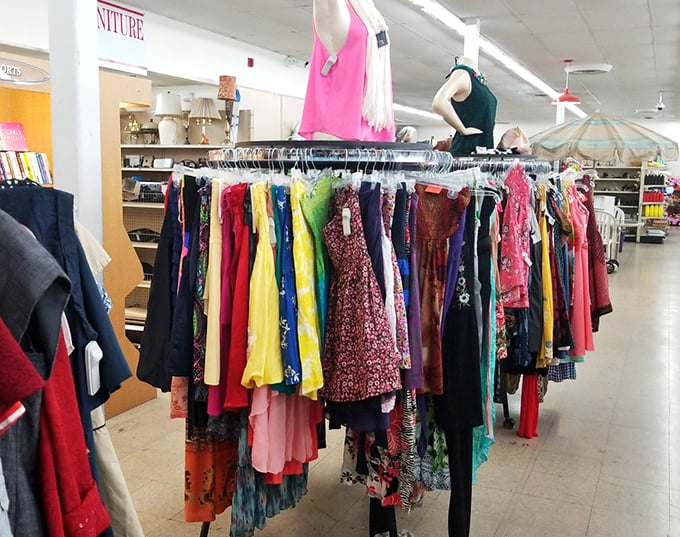 A rainbow of fabrics tells fashion stories spanning decades—each dress waiting for its second chance to make a first impression.