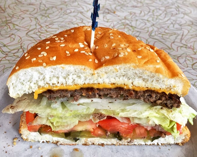 This isn't just a cheeseburger—it's architecture. The golden ratio of beef, cheese, and fresh veggies creates perfect harmony in every bite.