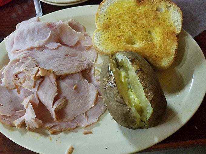 Smoked turkey that doesn't need a holiday to shine. That butter-soaked baked potato isn't just a side—it's a co-star in this delicious production.