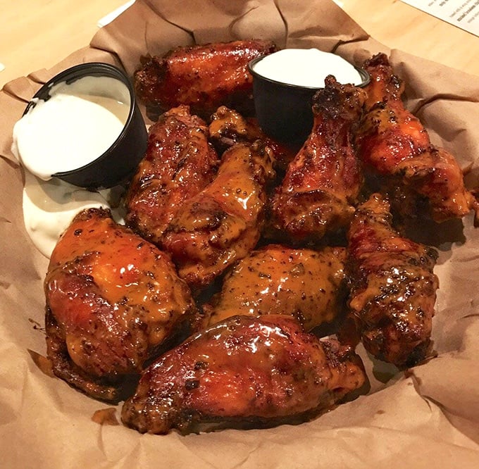 These smoked wings aren't just cooked, they're coaxed to perfection – glistening with sauce and promising a flavor explosion that'll haunt your dreams.