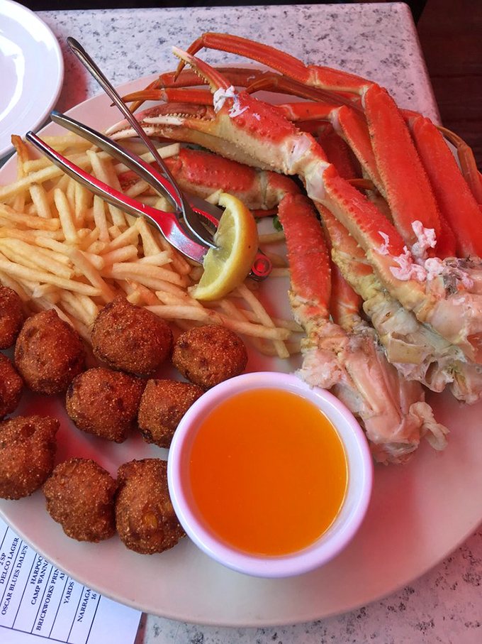 Snow crab legs, hush puppies, and fries—the holy trinity of seafood indulgence. That little cup of melted butter isn't just a condiment, it's liquid gold.