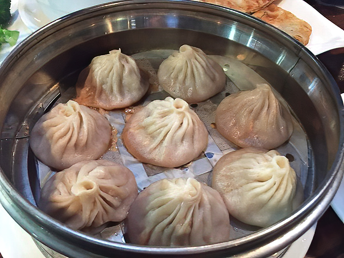 These soup dumplings aren't just food; they're little miracle pouches where physics and flavor unite in steamy, savory perfection.