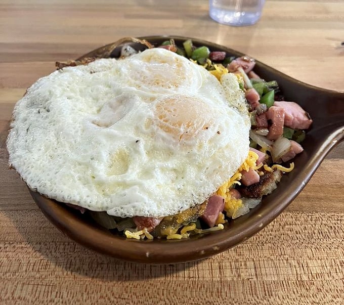 Eggs that know exactly what they're doing, perched atop a mountain of savory ingredients. This skillet doesn't just feed you—it prepares you for adventure.