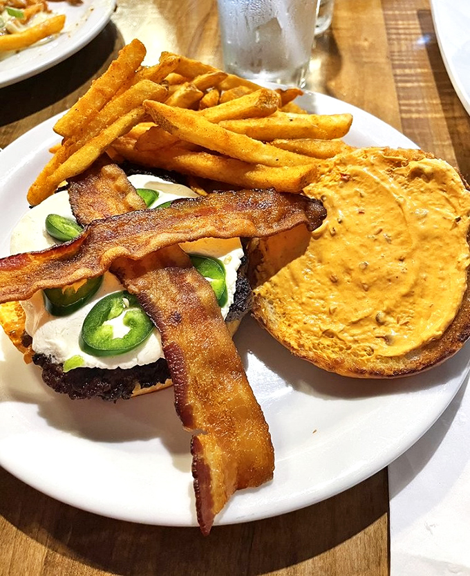 The Spicy Goat Burger arrives like a flavor explosion, with jalapeños and goat cheese playing the perfect spicy-creamy duet.
