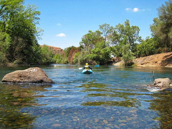 The Stanislaus River offers nature's air conditioning—a crystal-clear respite where kayakers discover why locals treasure this waterway as Oakdale's liquid gold.
