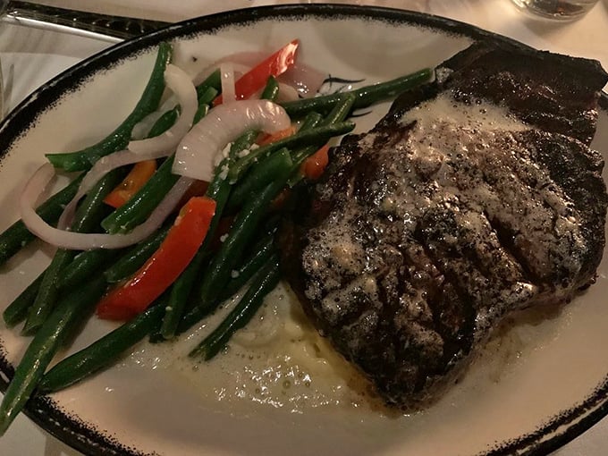 Behold the star of the show – a perfectly seared steak with textbook grill marks, accompanied by vibrant green beans that provide the illusion of healthfulness.