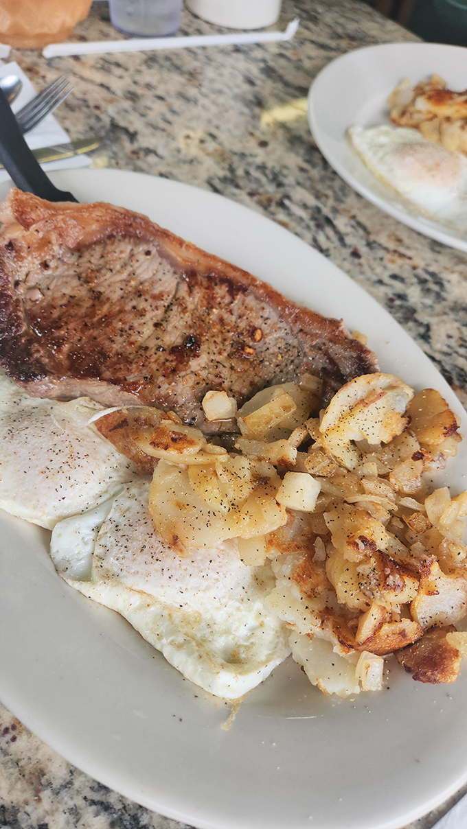 Steak and eggs: the breakfast of champions who plan to skip lunch. That perfectly seasoned home fries side act isn't playing a supporting role—it's stealing the show.