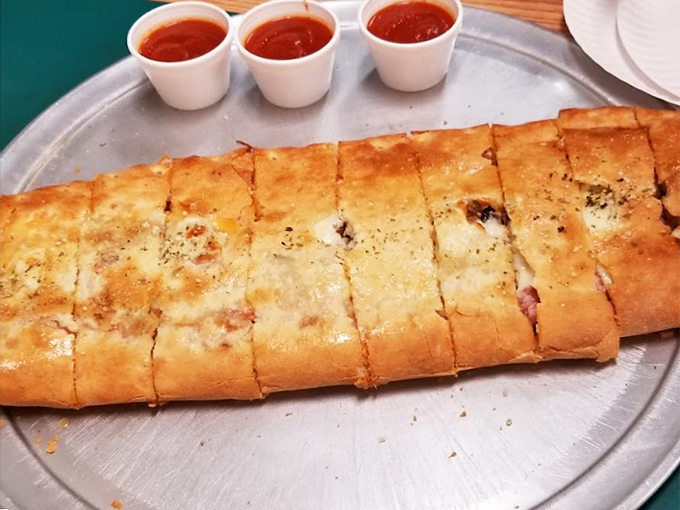 Behold the stromboli in all its golden glory – a perfectly sealed envelope of deliciousness that delivers better news than your tax refund.