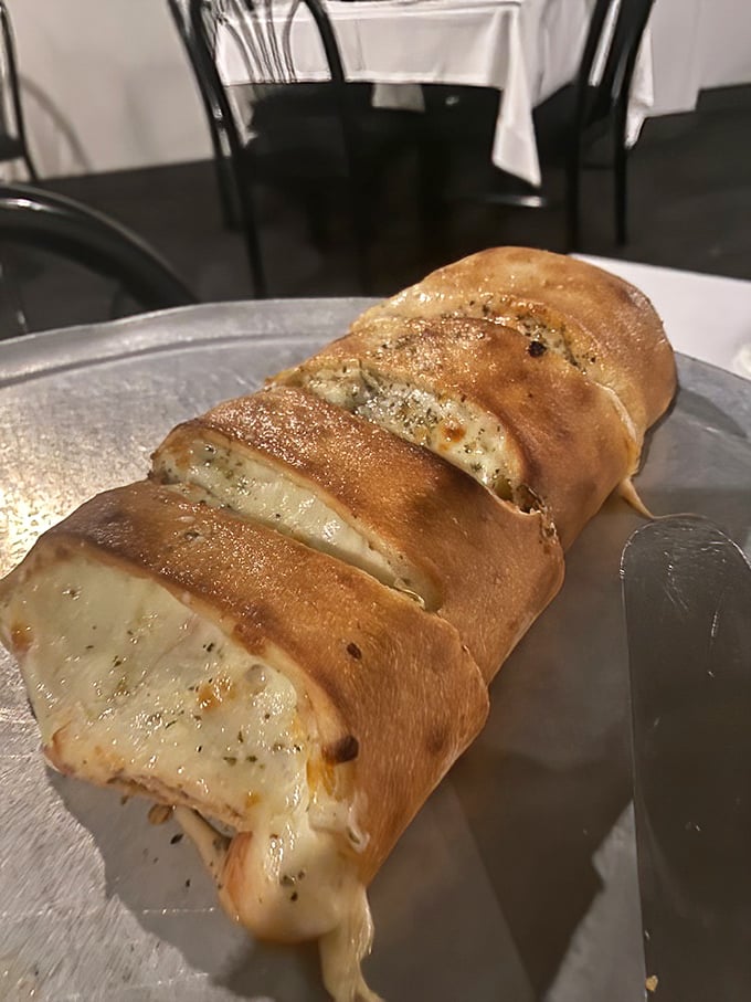 This stromboli isn't just food—it's architecture. Golden-brown exterior giving way to a molten interior that stretches like the world's most delicious suspension bridge.