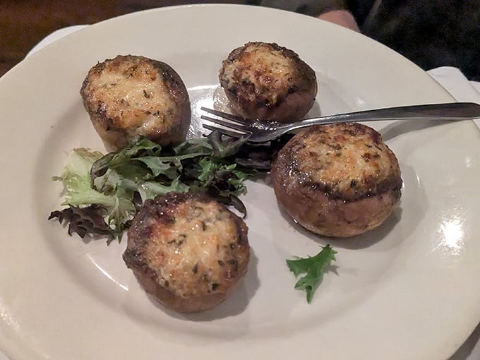 These aren't just stuffed mushrooms – they're edible treasure chests. Each golden-brown cap delivers a payload of savory filling that'll haunt your dreams.