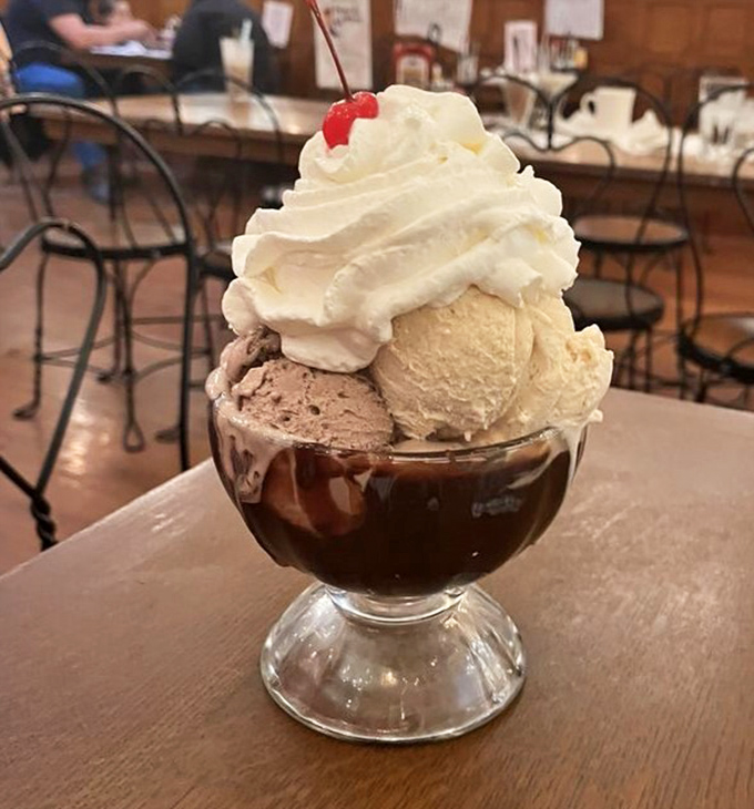 This isn't just a sundae – it's architecture in a glass, with scoops of ice cream balanced precariously above hot fudge like a delicious game of Jenga.