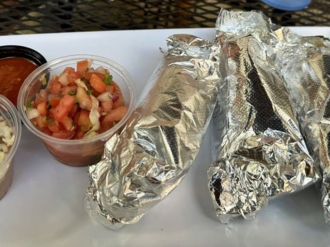 Foil-wrapped treasures flanked by fresh pico de gallo—proof that sometimes the best gifts come in simple packages.