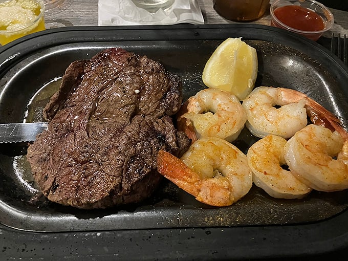 Surf and turf perfection on a sizzling platter. That steak isn't just cooked—it's been sweet-talked to tenderness alongside plump, succulent shrimp.