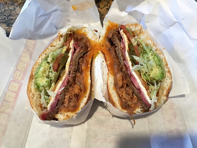The legendary Torta Cubana in all its glory – a skyscraper of meats, cheese, and veggies that requires both hands, several napkins, and absolutely zero shame.