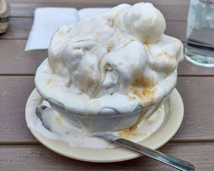 Mount Vanilla! This towering masterpiece of ice cream isn't just dessert—it's architecture with a cherry on top and a spoon standing by for demolition.