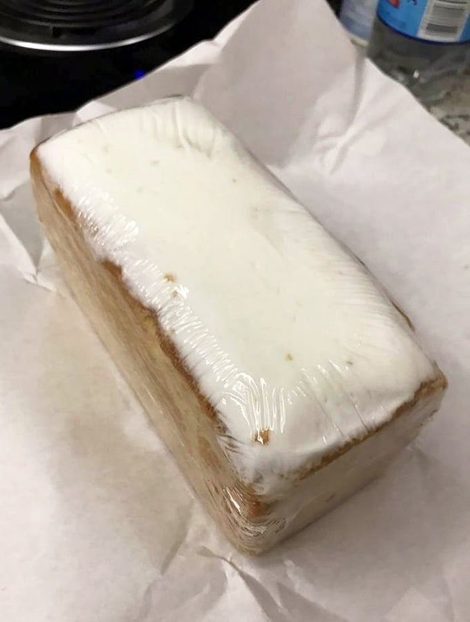 The holy grail of pound cake – wrapped in plastic like the culinary treasure it is. Dense, moist, and worth every calorie.