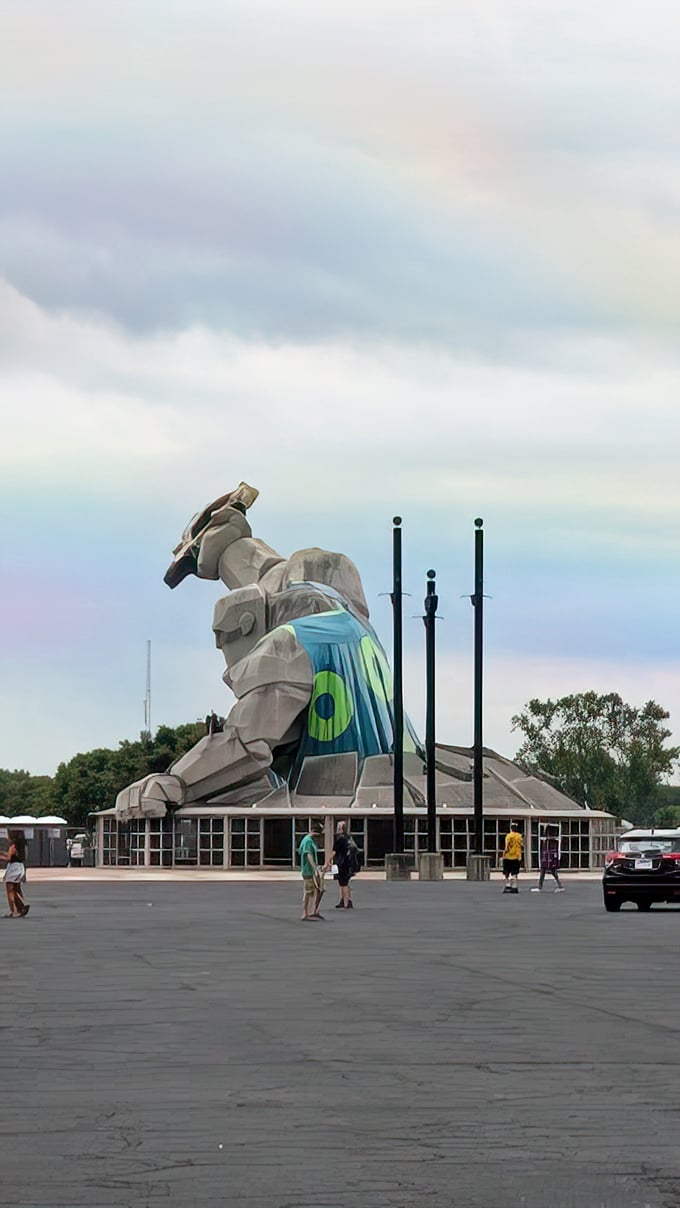 From behind, Miles reveals his true scale against the Delaware sky. That's not a backpack—it's a full-sized race car he's casually hoisting.