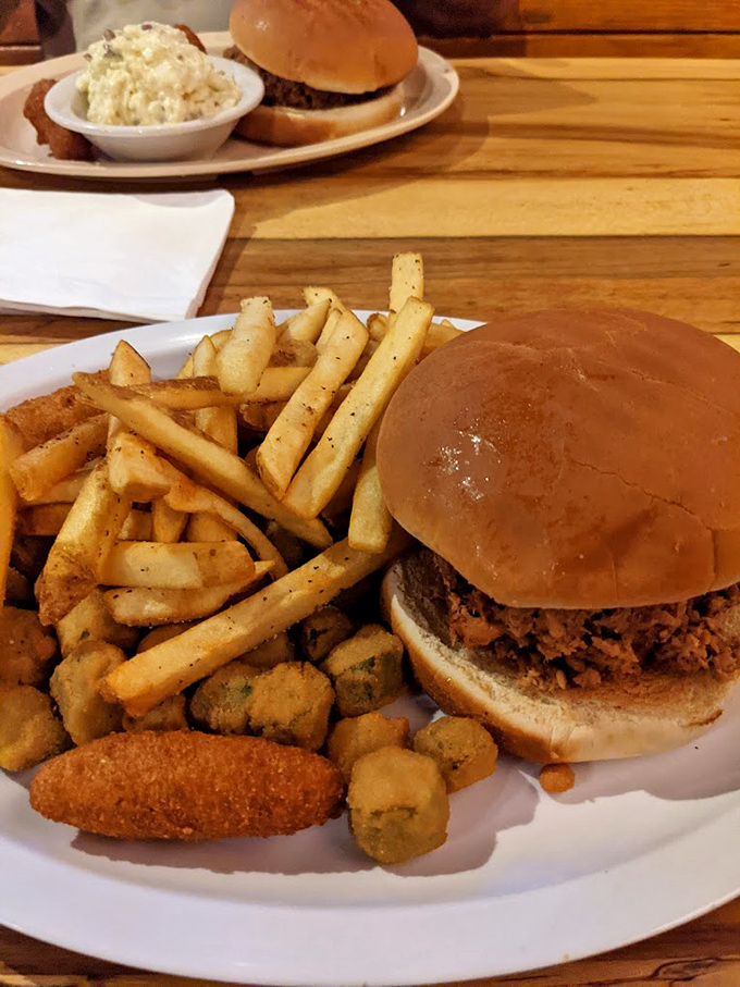Behold the sandwich that could end all barbecue debates: tender pulled pork piled high with golden fries as loyal sidekicks.