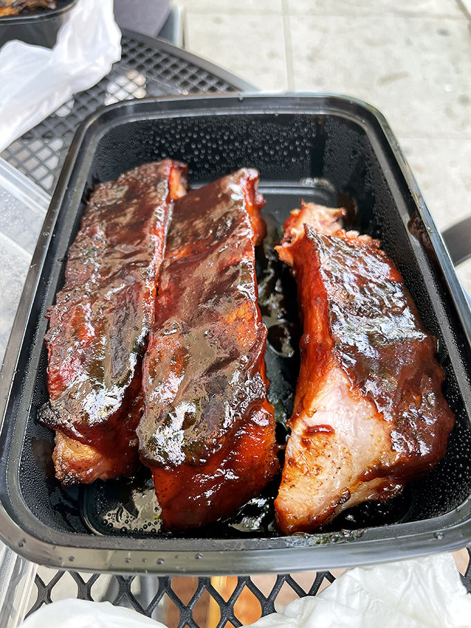 These ribs aren't just falling off the bone—they're practically jumping into your mouth. The glistening sauce and perfect smoke ring tell you everything you need to know.
