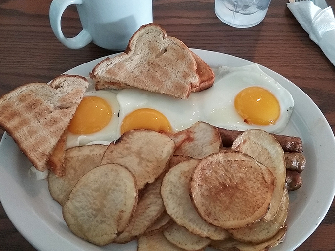 Breakfast perfection doesn't need fancy plating—just perfectly sunny-side-up eggs, home fries with that ideal crisp, and toast waiting for its butter bath.