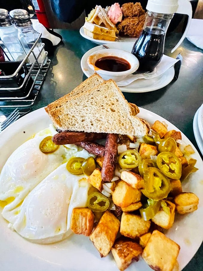 Eggs, potatoes, jalapeños, and toast—a breakfast symphony where every instrument plays in perfect harmony. The crispy potatoes deserve their own fan club.